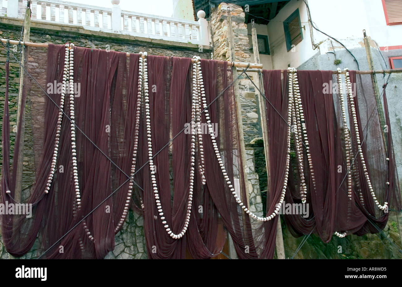 red fish net drying outdoor in cudillero galice north spain village of ...