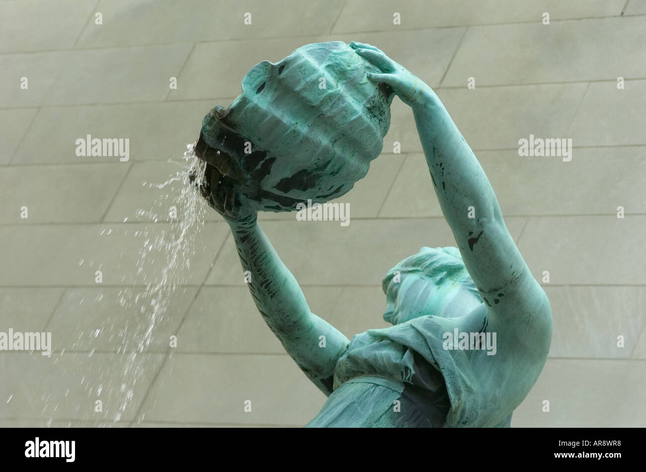 female statue puring water from a shell Stock Photo - Alamy