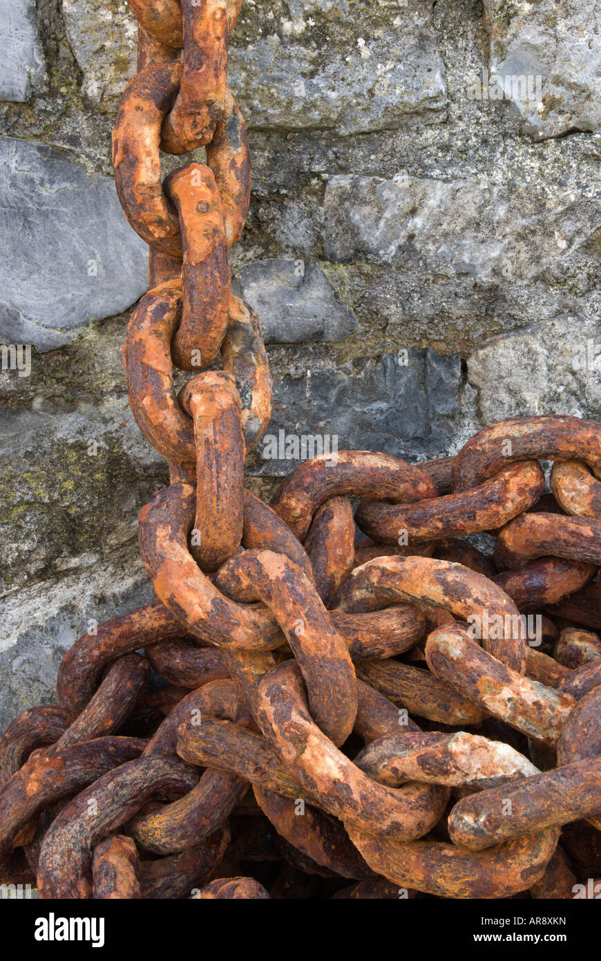A stone wall & rusting anchor chain taken at Tenby Harbour West Wales ...