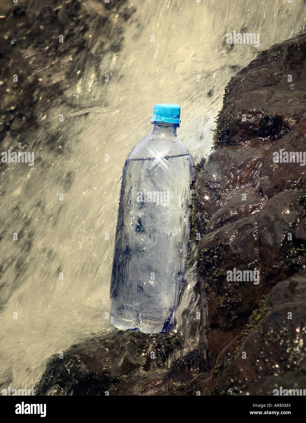 Generic bottle of water near or alongside a waterfall Stock Photo - Alamy