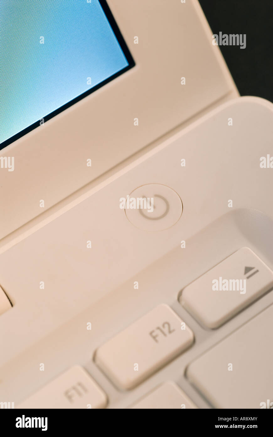 a closeup of the power button on a laptop computer also showing part of ...