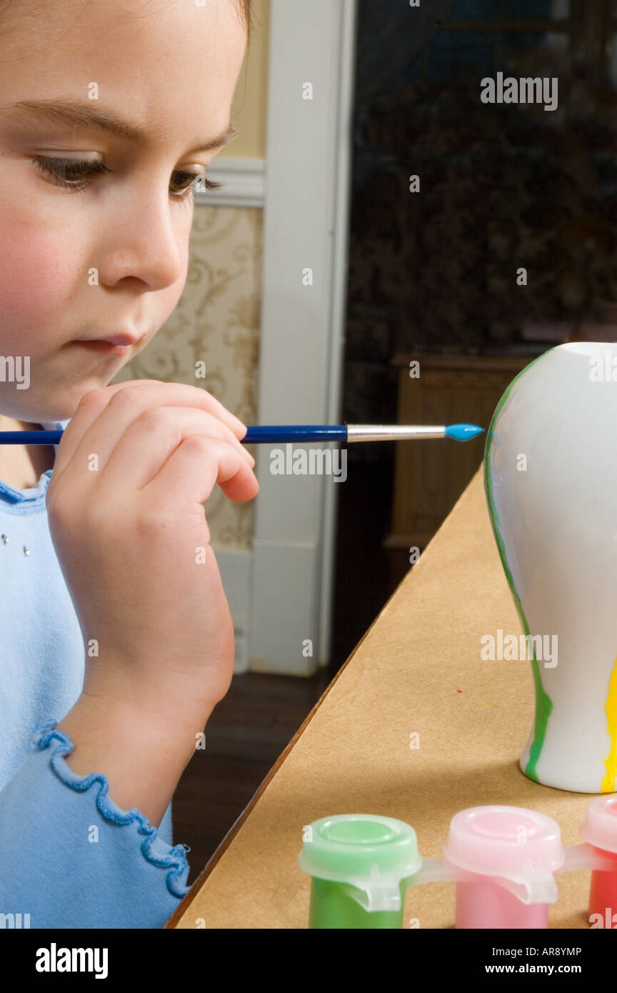 Little girl painting pottery Stock Photo - Alamy