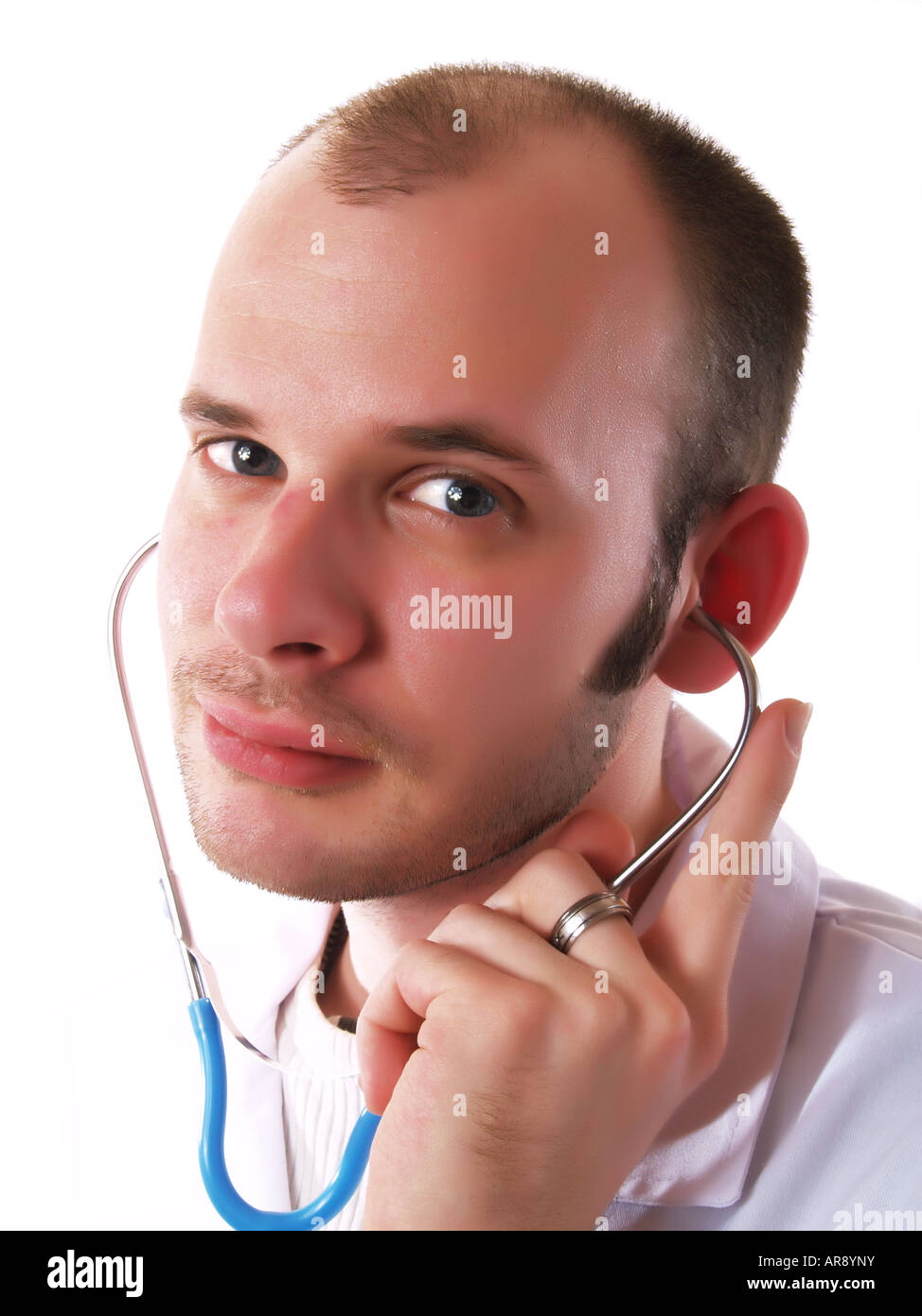 Young doctor using a stethoscope and smiling Stock Photo - Alamy