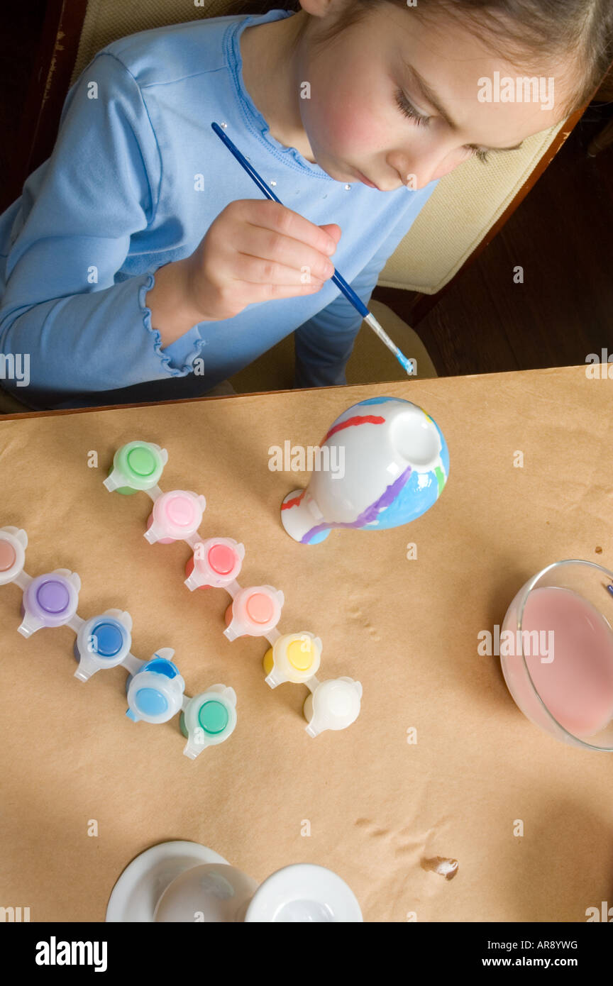Little girl painting pottery Stock Photo - Alamy