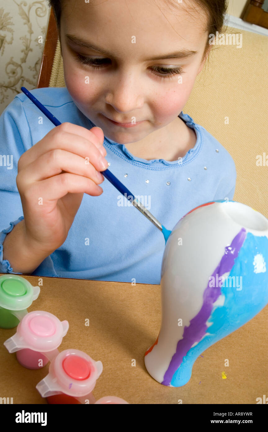 Little girl painting pottery Stock Photo - Alamy