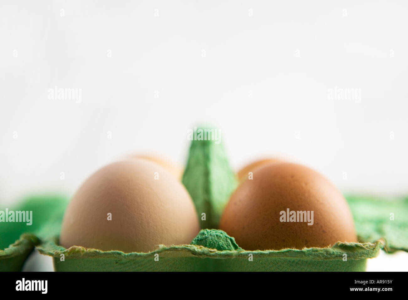 Green Egg Box with four Eggs Stock Photo - Alamy