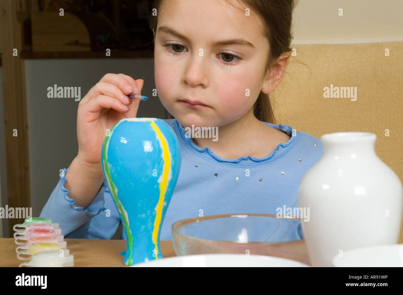 Little girl painting pottery Stock Photo - Alamy