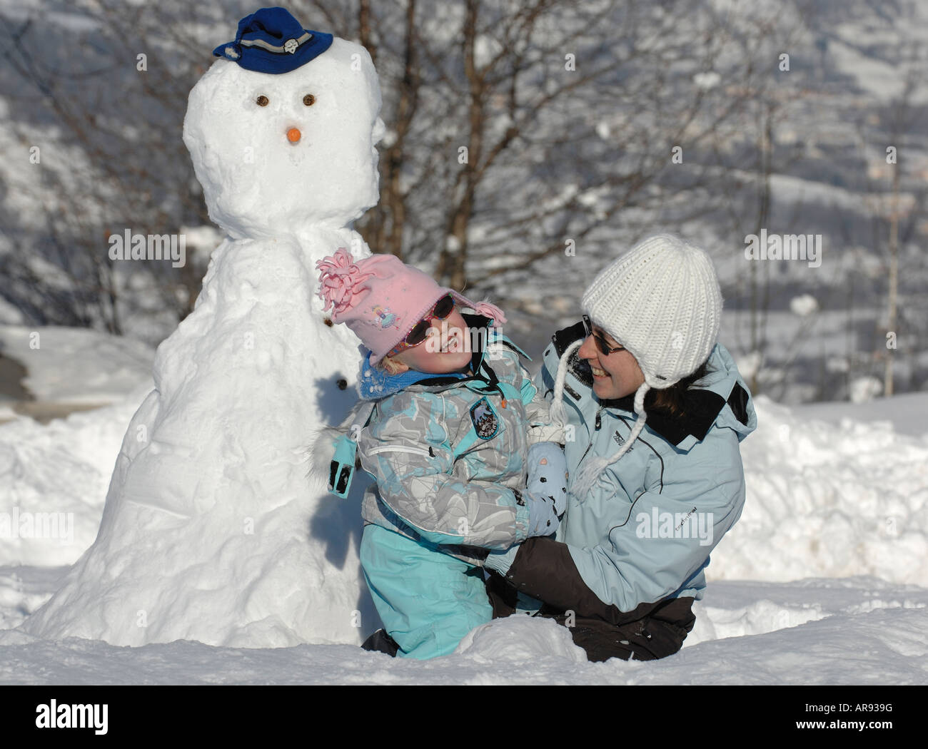 A woman and young child playing in the snow Montchavin Les Coches part ...
