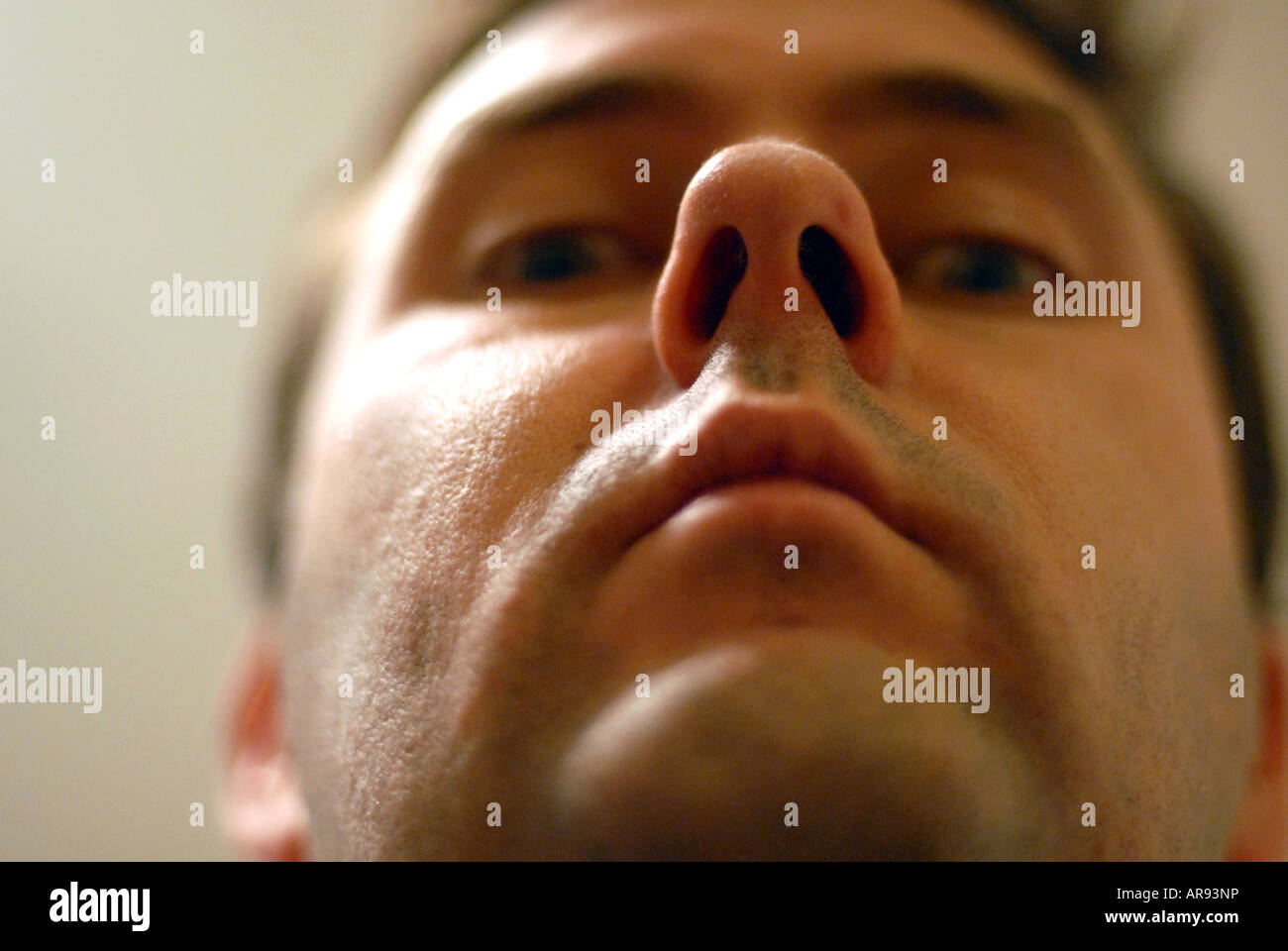 Man looking suspiciously down on you Stock Photo - Alamy