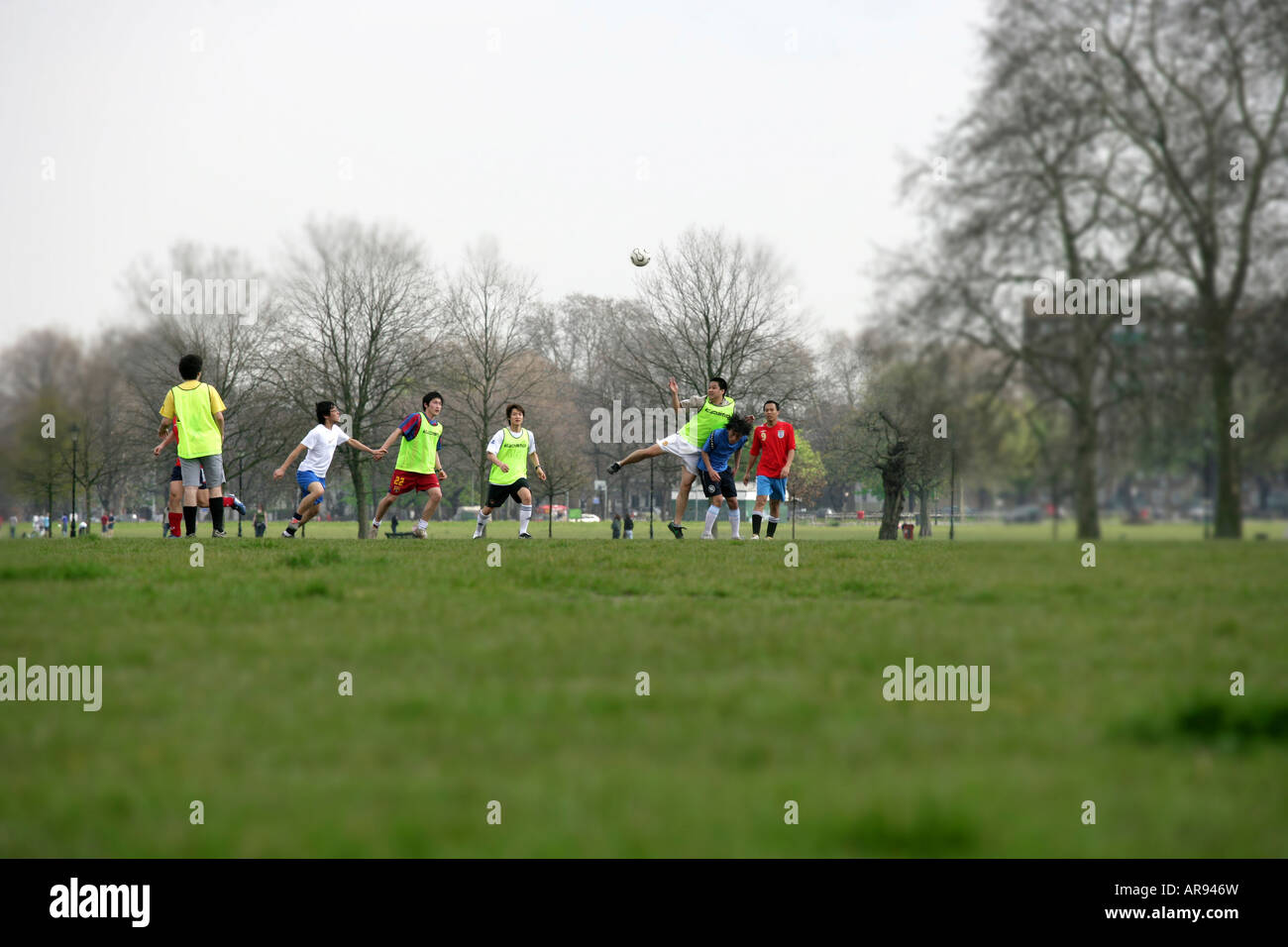 playing football in the park Stock Photo - Alamy