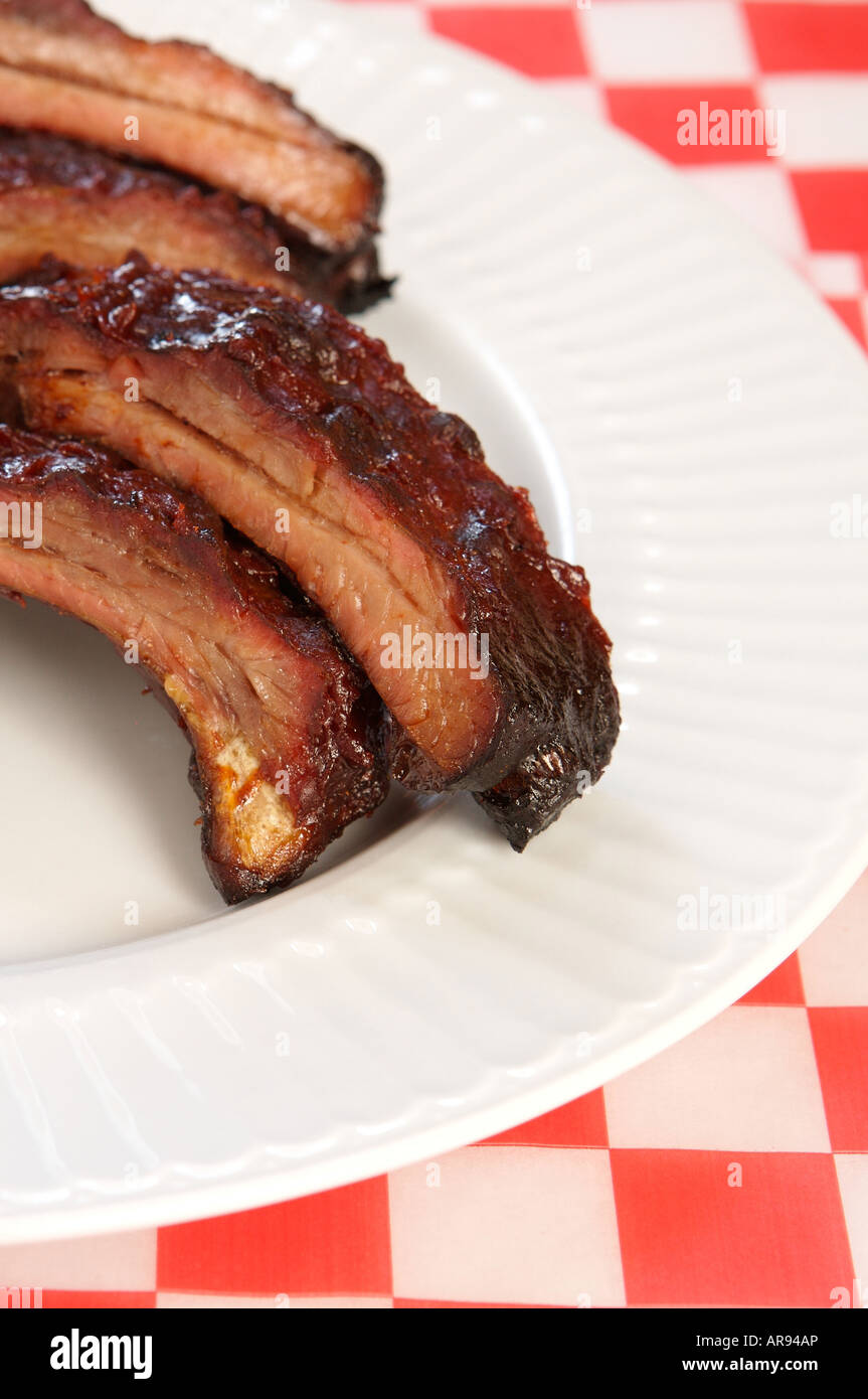 Babyback spare barbeque pork ribs on a checkered restaurant tissue ...