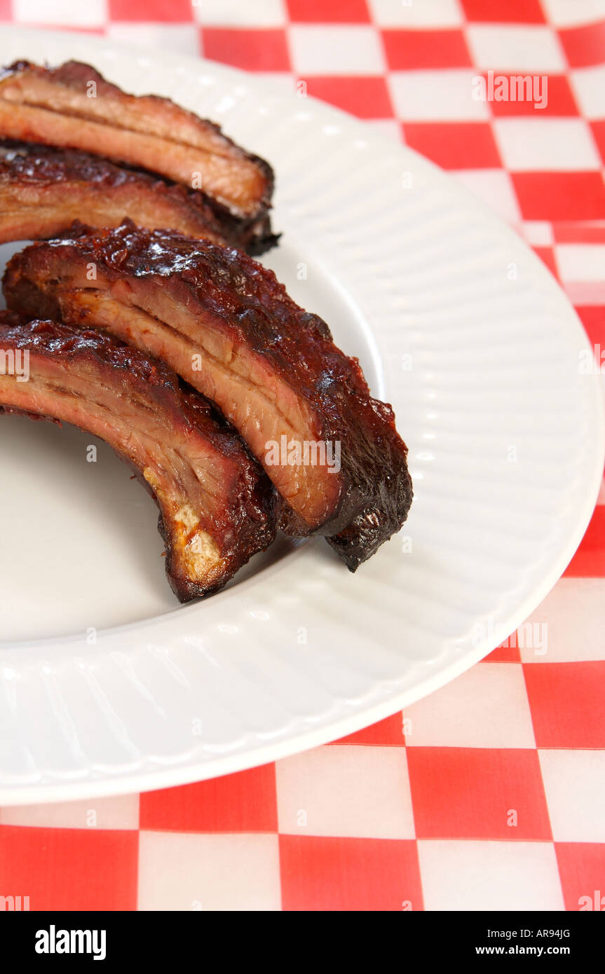 Babyback spare barbeque pork ribs on a checkered restaurant tissue ...