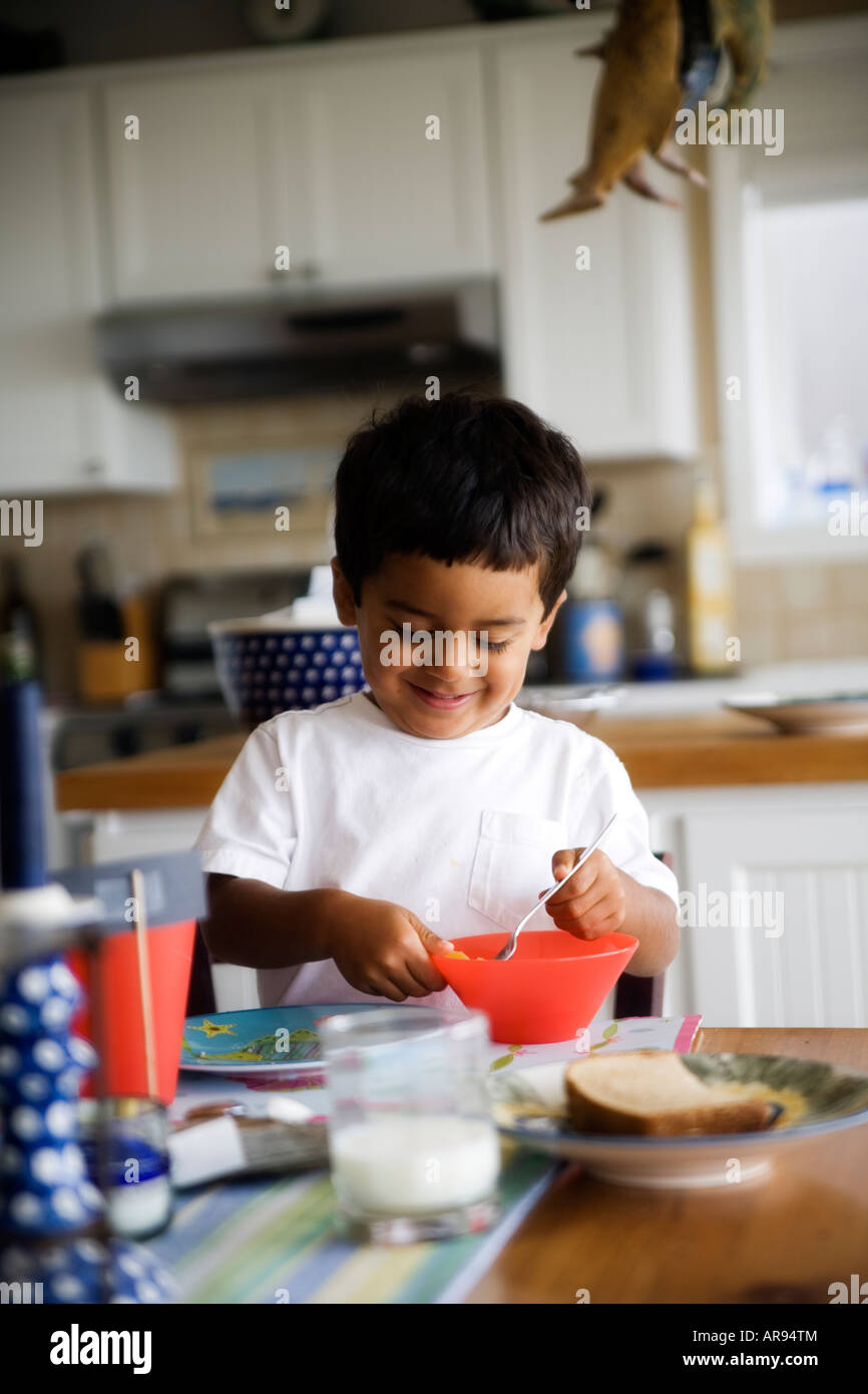 young cute boy eating breakfast Stock Photo - Alamy