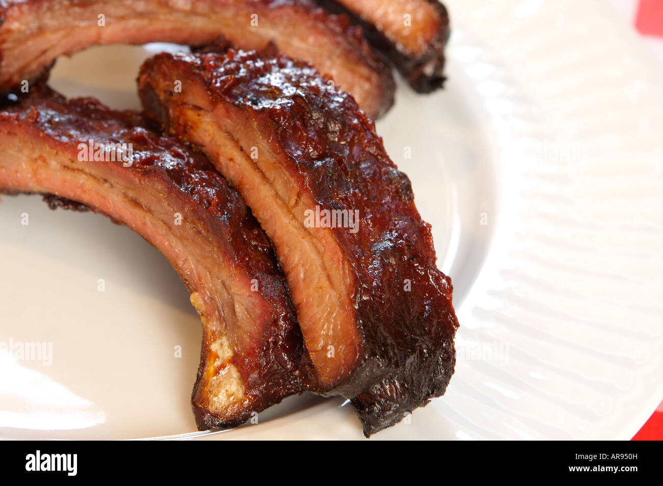 Babyback spare barbeque pork ribs on a checkered restaurant tissue ...