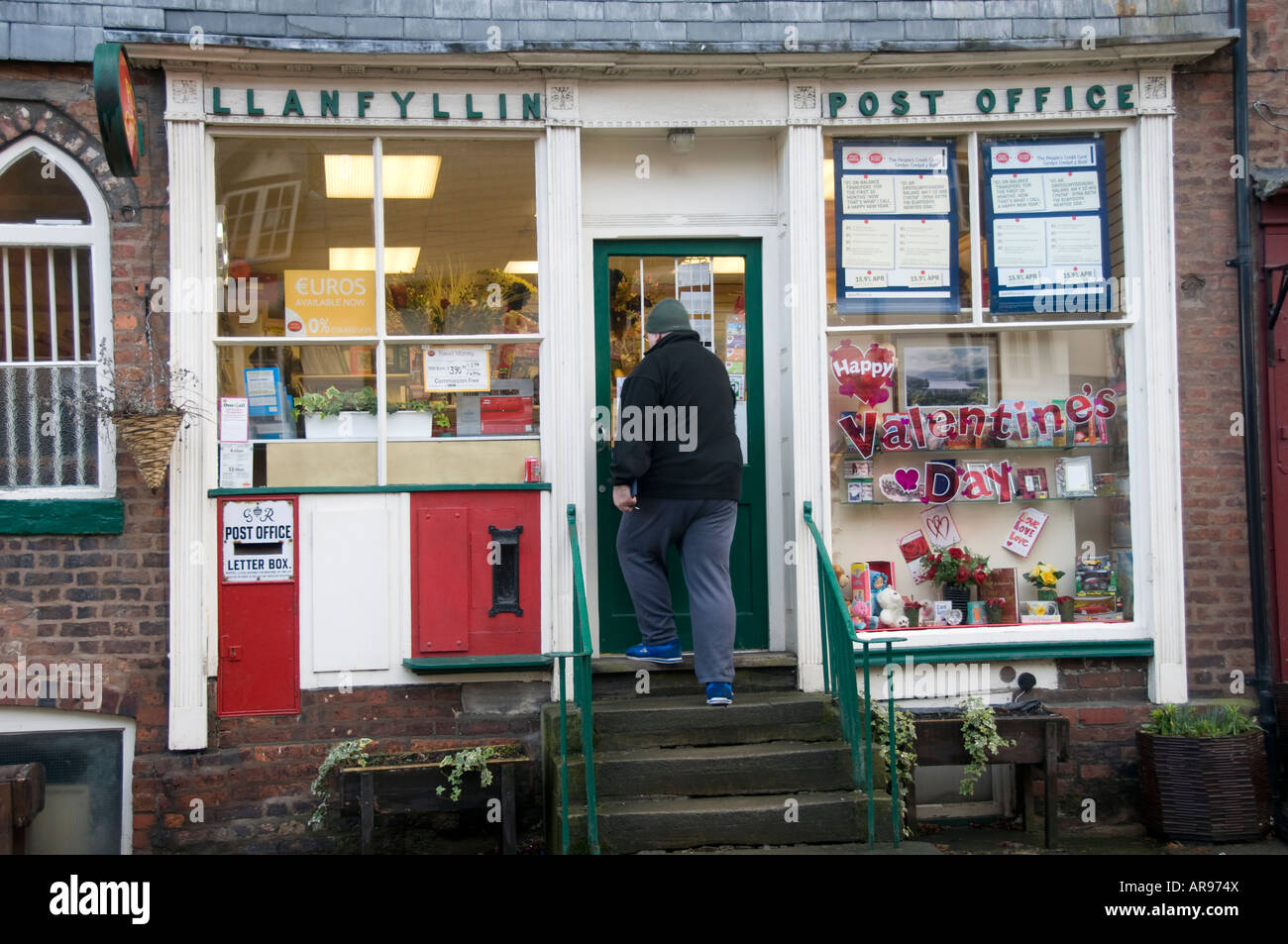 Man walking into Small rural post office Llanfyllin village north Powys ...