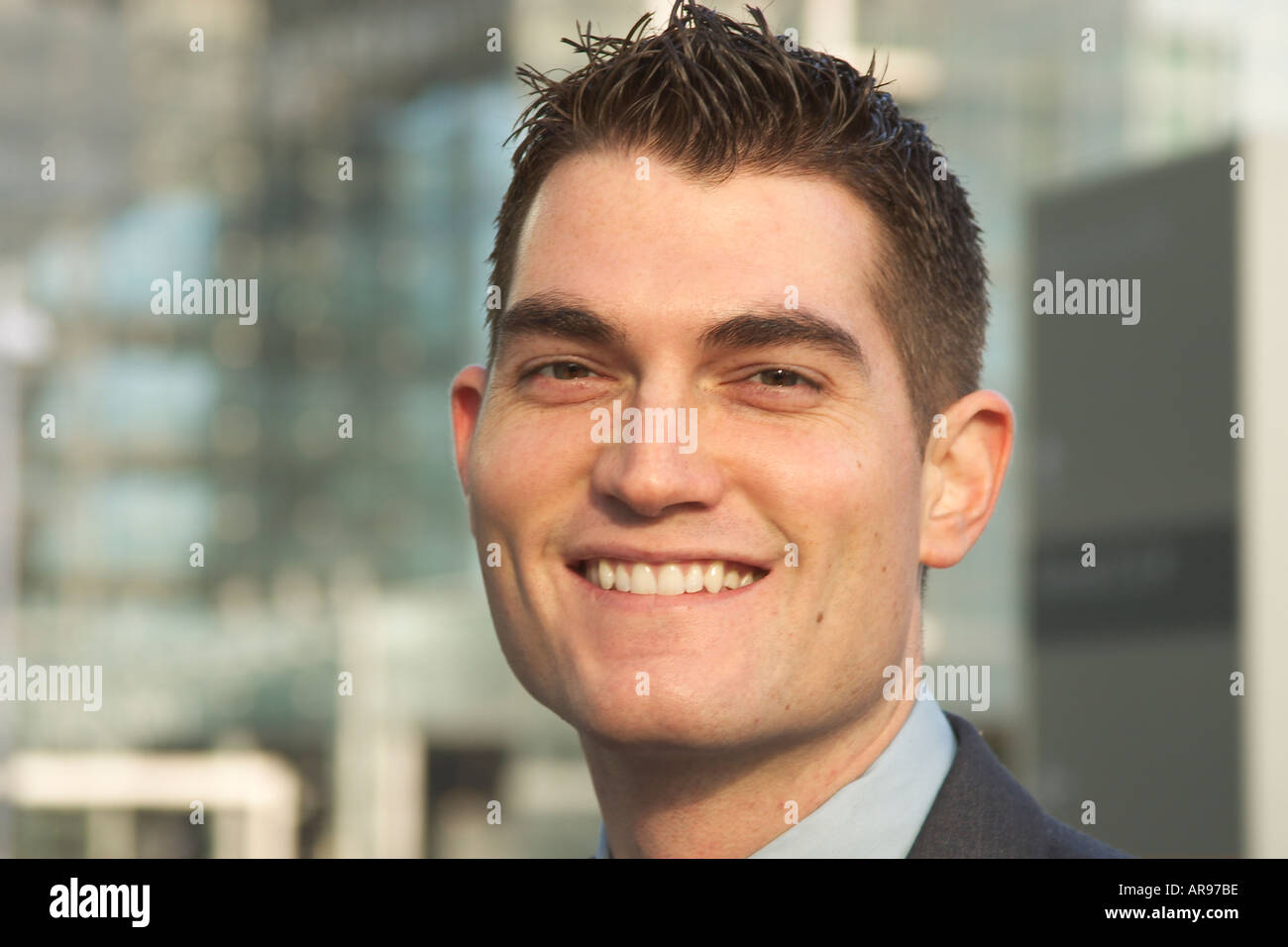 Young man smiles friendly Stock Photo - Alamy