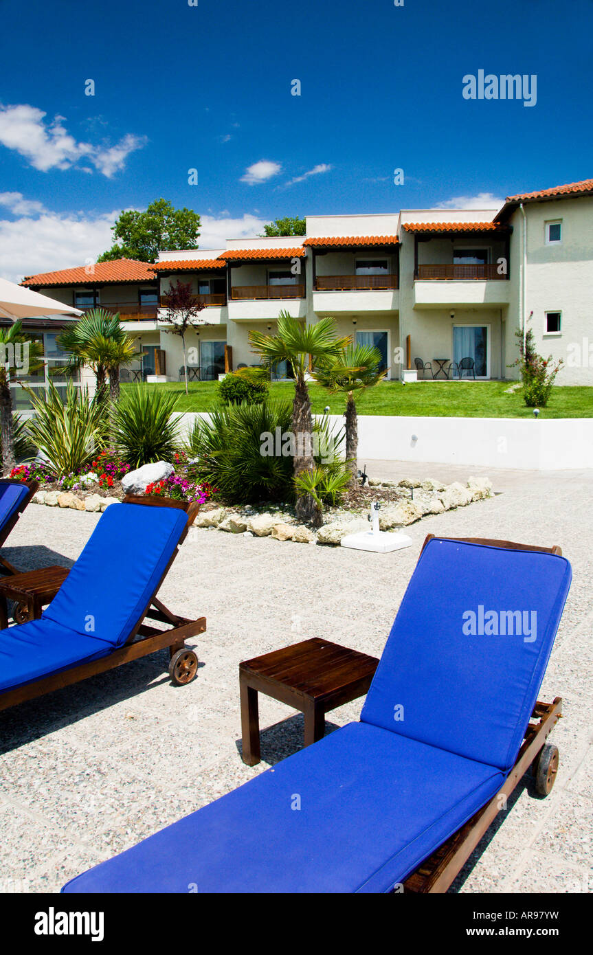 Pool area with blue lounge chairs at the Dion Palace Resort in Litohoro ...