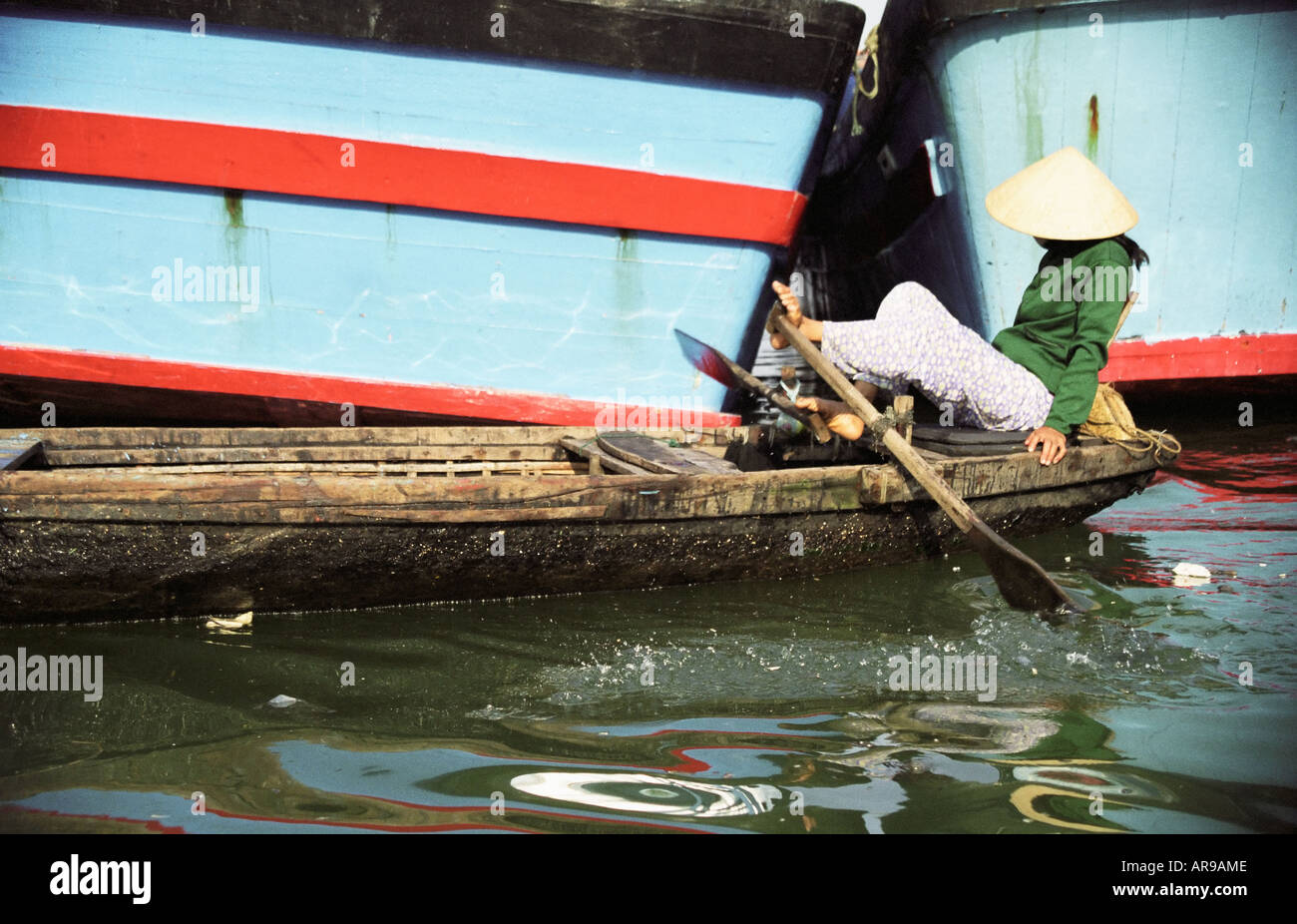 Woman Paddling Boat With Feet Stock Photo - Alamy