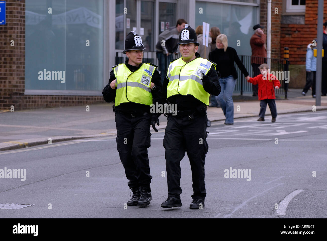 to 2 policemen walking down the street on the beat weraing high ...