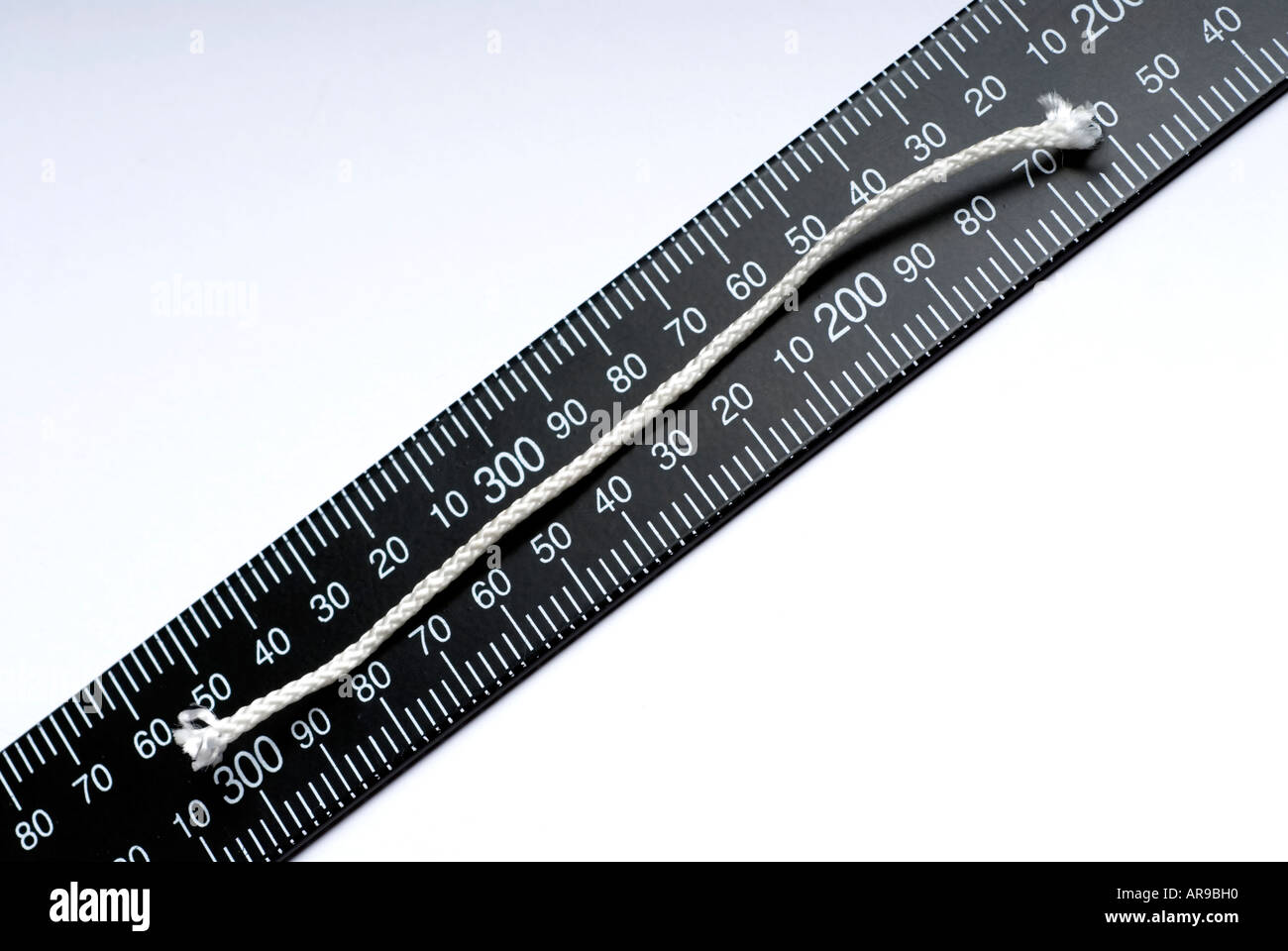 Image of a piece of string being measured against a ruler Stock Photo ...
