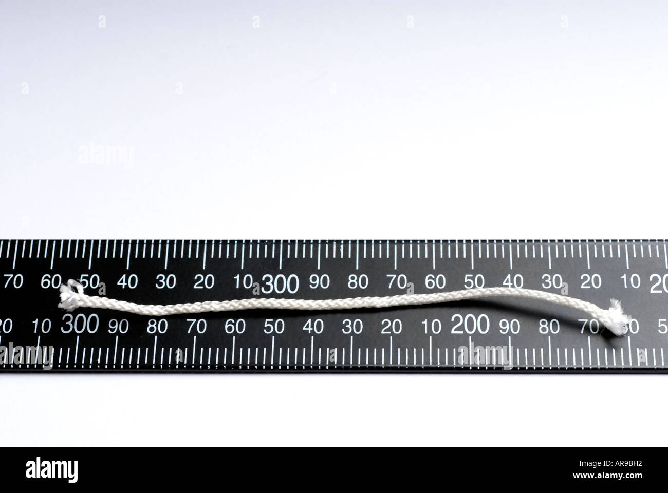 Image of a piece of string being measured against a ruler Stock Photo ...