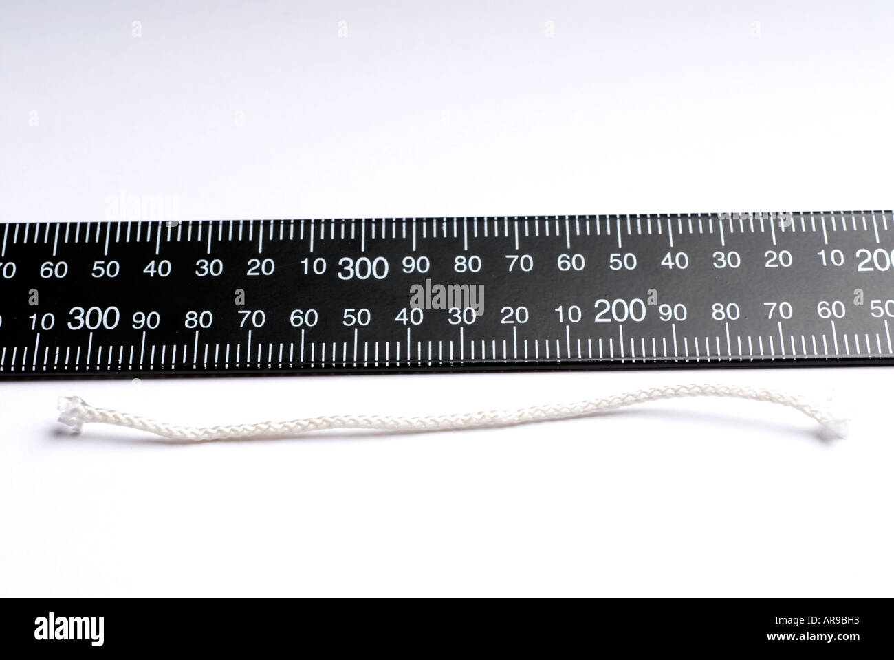 Image of a piece of string being measured against a ruler Stock Photo ...