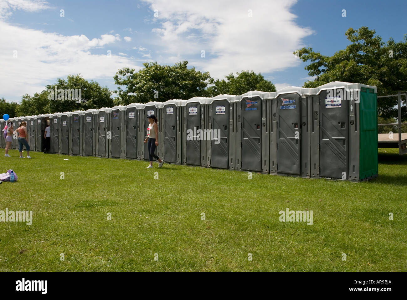 Image of a large row of temporary portable toilets set up for the race ...