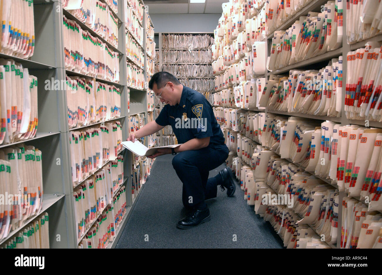 Records room Sargent looking through criminal files Stock Photo - Alamy