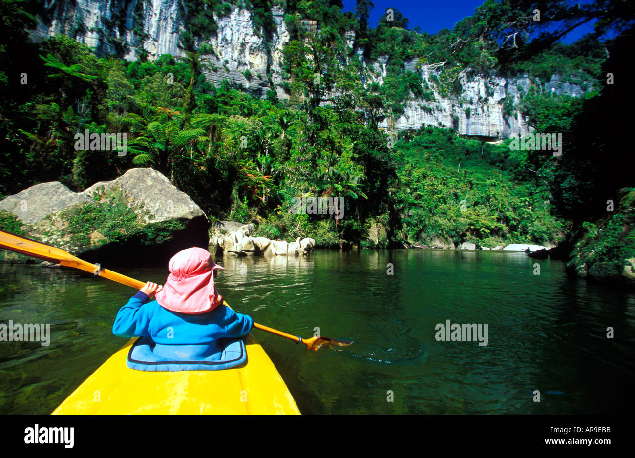 Young boy kayaking on the Pororari River West Coast of South Island ...