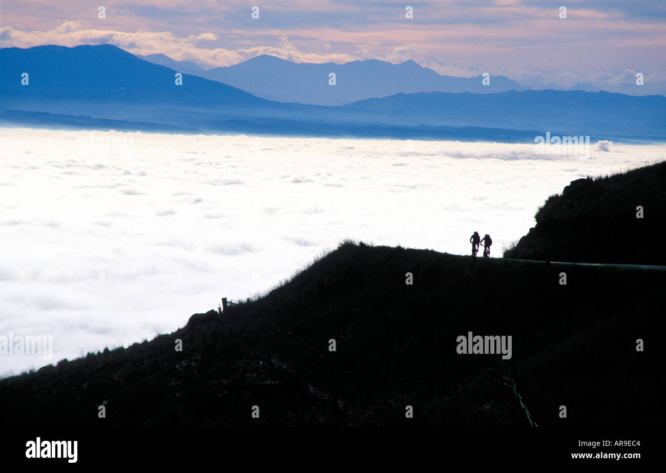 Two cyclists above the city smog Port Hills in June Christchurch New ...