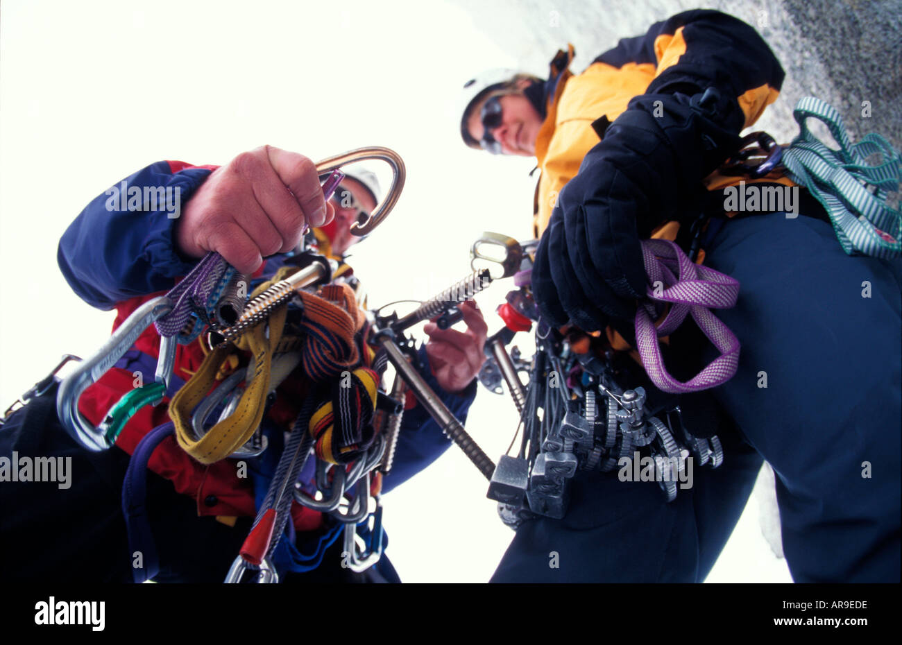 Two climbers checking gear before their ascent Stock Photo - Alamy