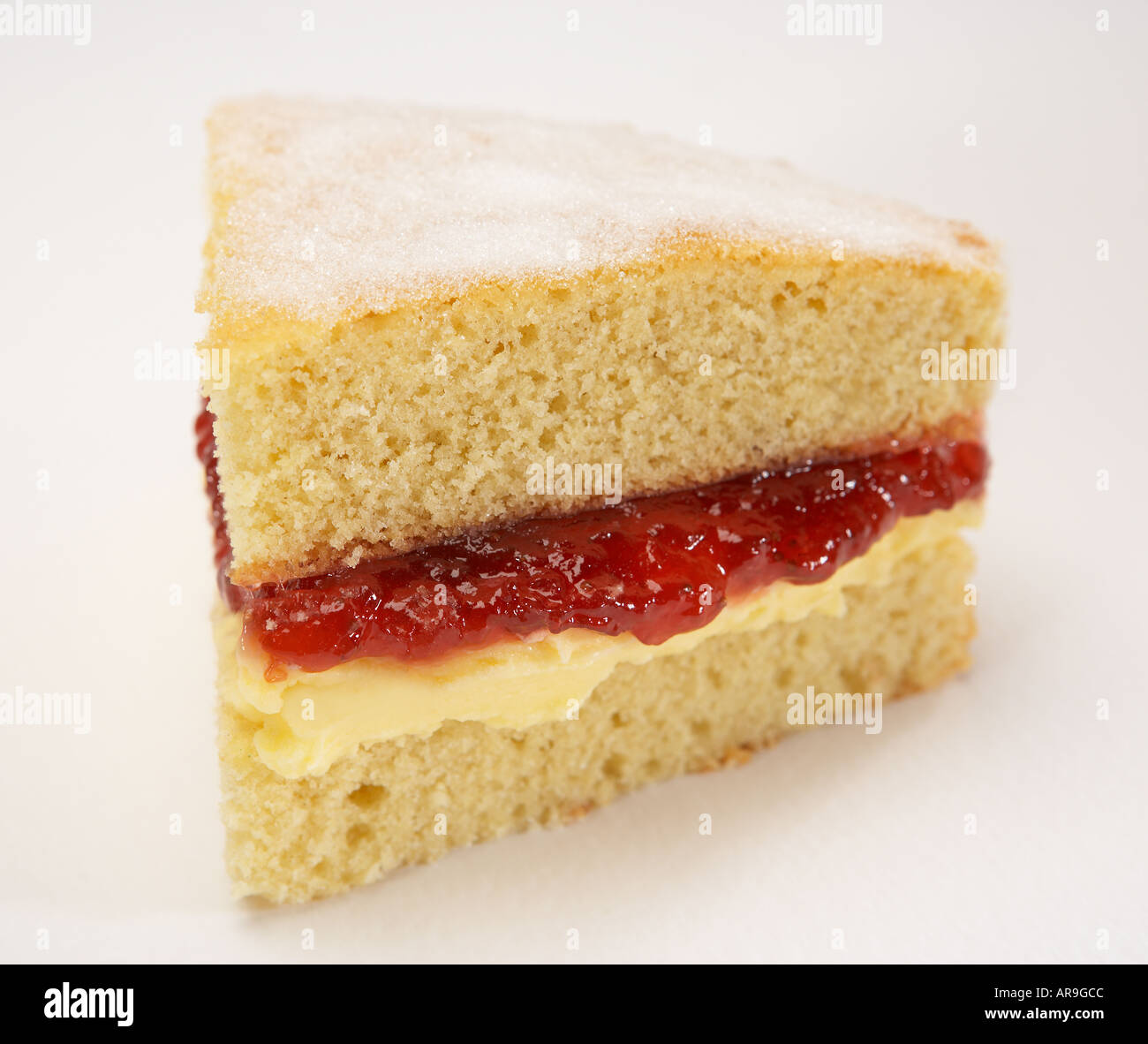 SINGLE SLICE OF JAM AND CREAM SPONGE CAKE ON WHITE BACKGROUND Stock ...