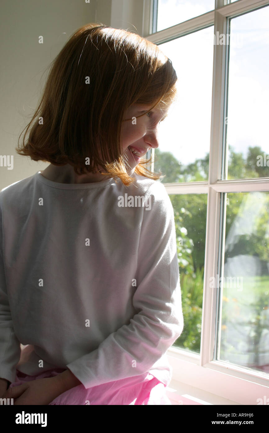 A child sat looking out of a window Stock Photo - Alamy