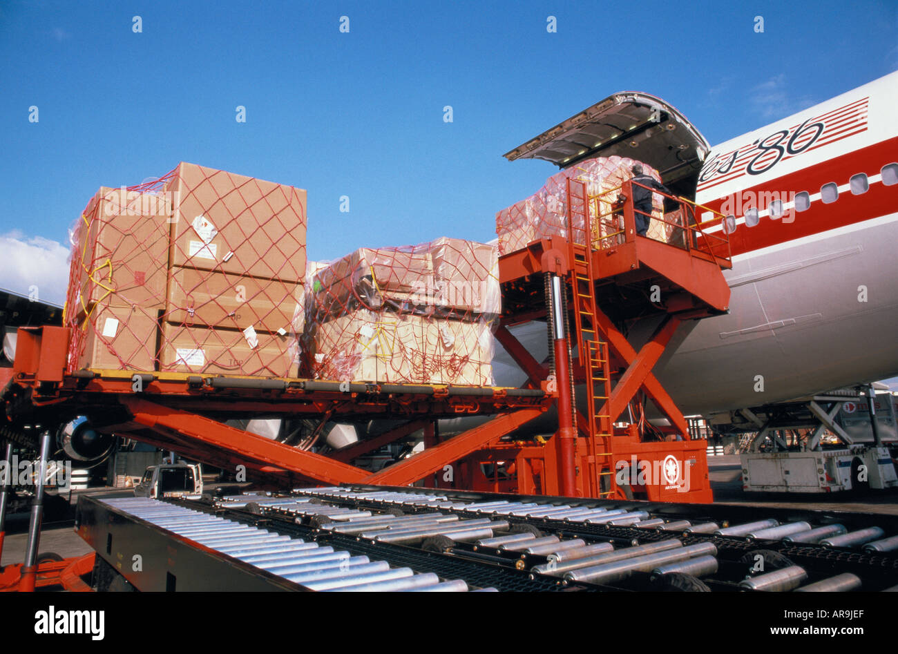 Boeing 747 jumbo jet loading cargo freight containers pallets against a ...