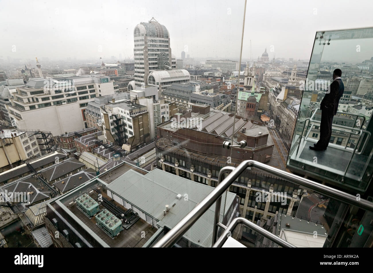 View over London from the Lloyds building taken from within a lift or ...