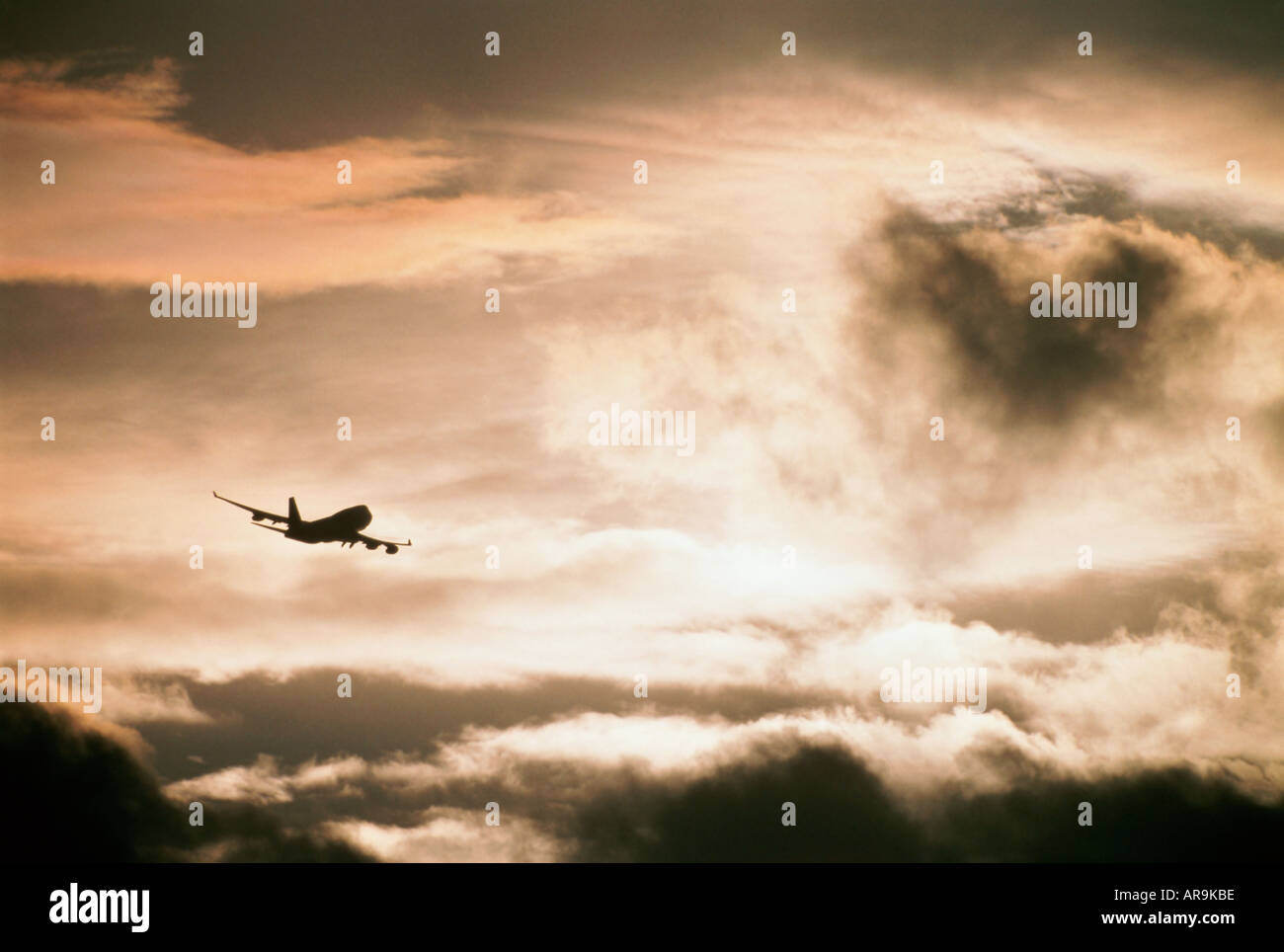 Boeing 747 jumbo jet airliner flying in the air cruising in a cloudy ...