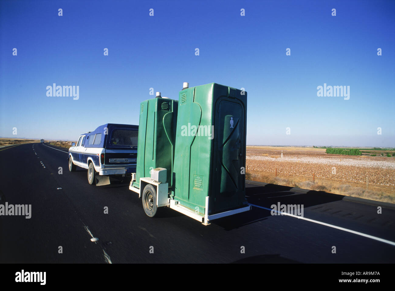 Mobile toilets or portable units called PUs rolling down highway on ...