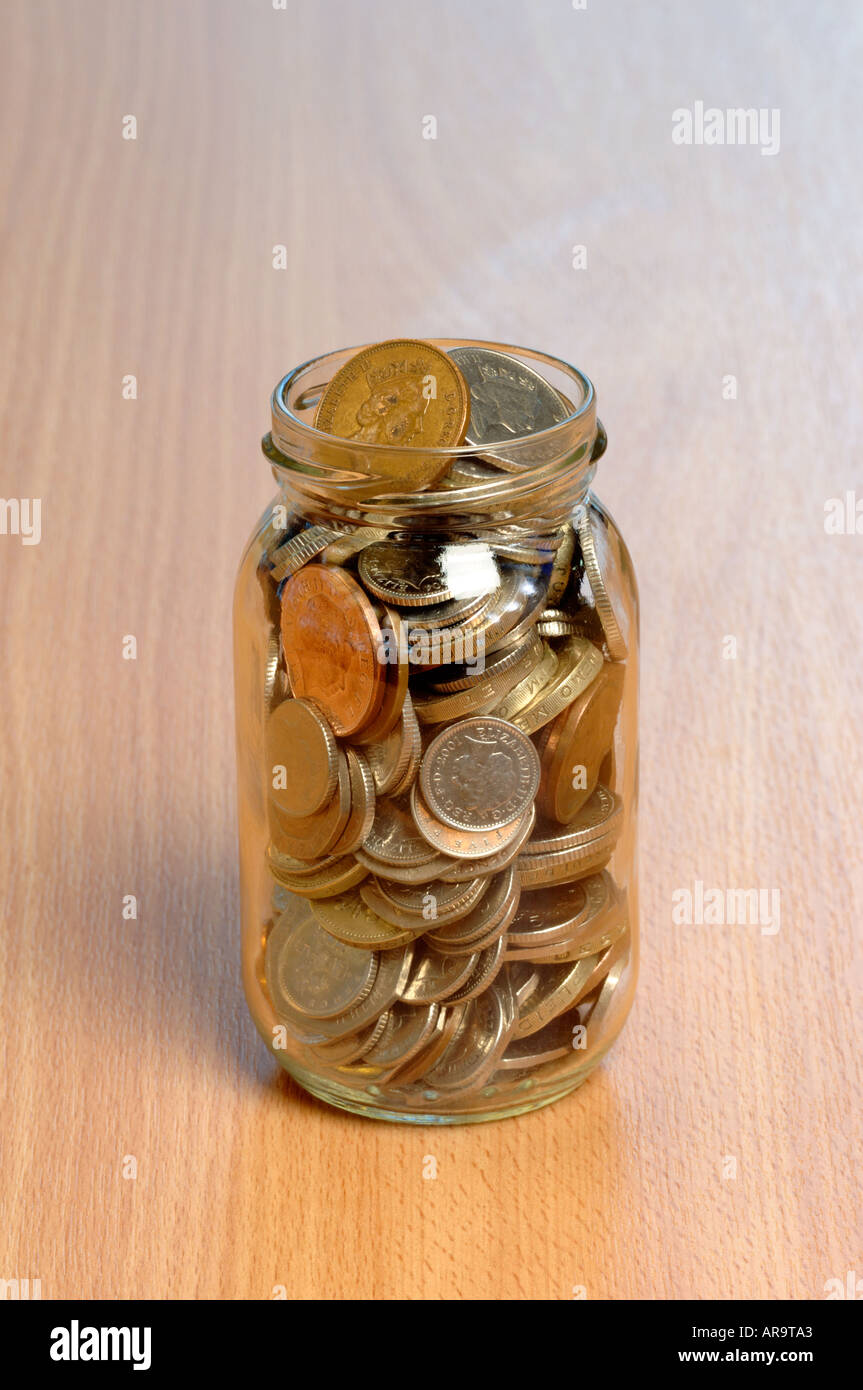 Glass jar of loose change Stock Photo - Alamy