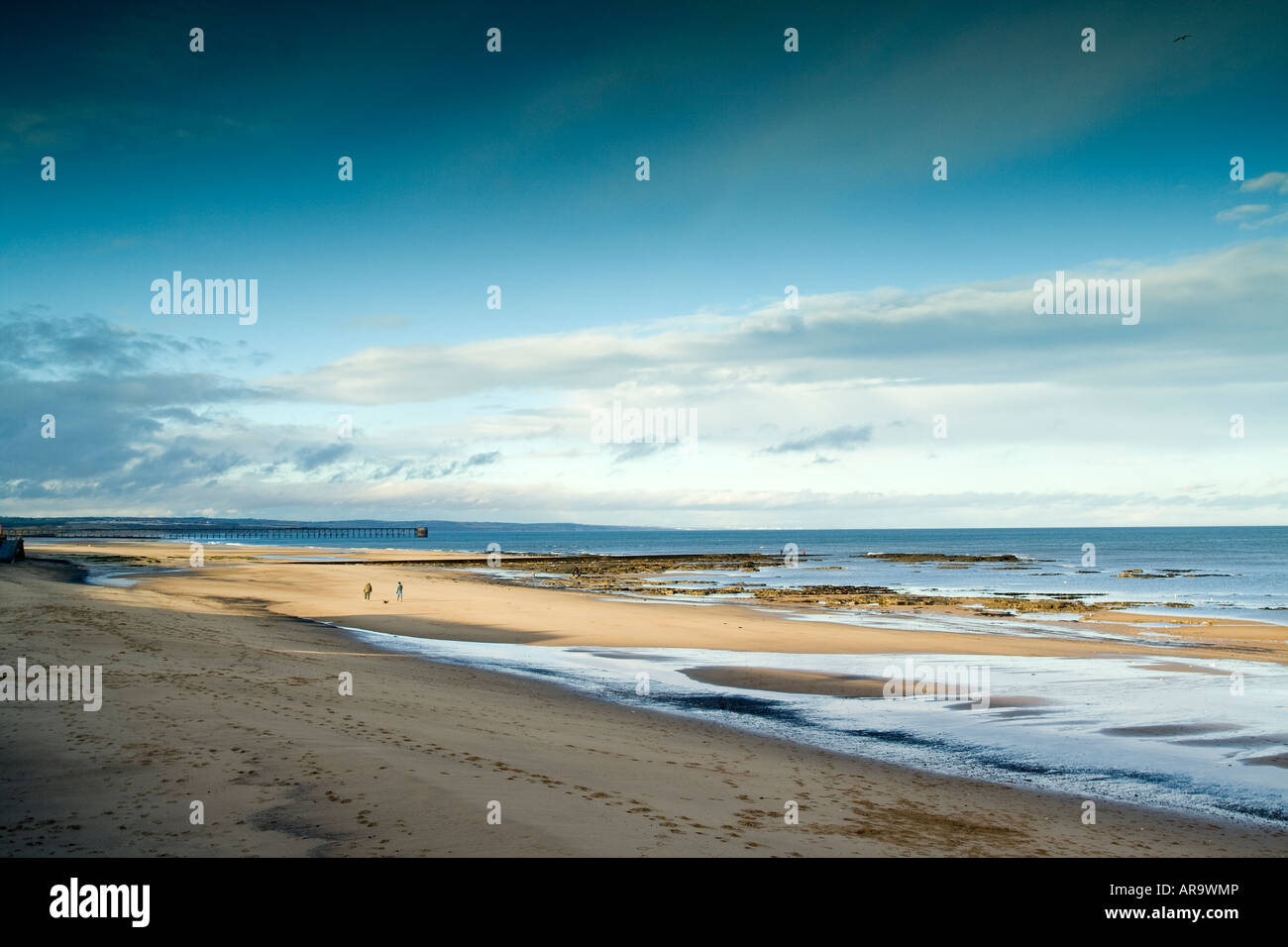 A sweeping beach scene with a very atmospheric sky Stock Photo - Alamy