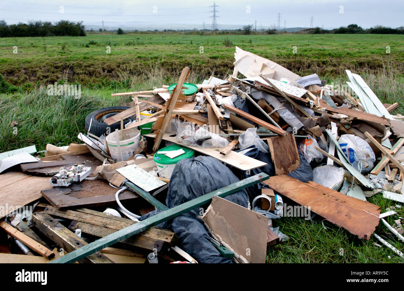 Household and building waste dumped on the roadside next to farmland in ...