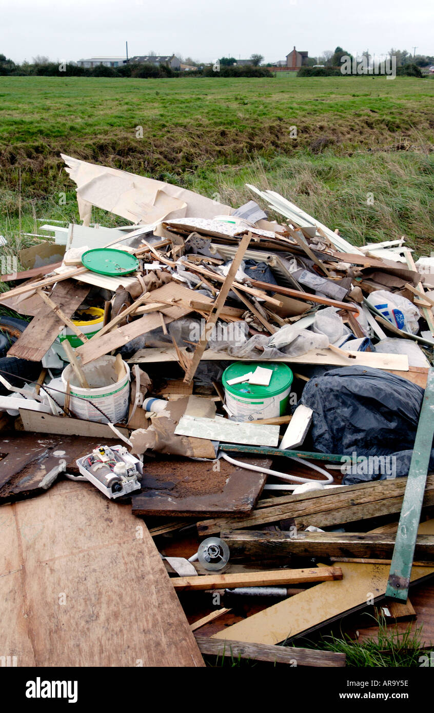 Household and building waste dumped on the roadside next to farmland in ...