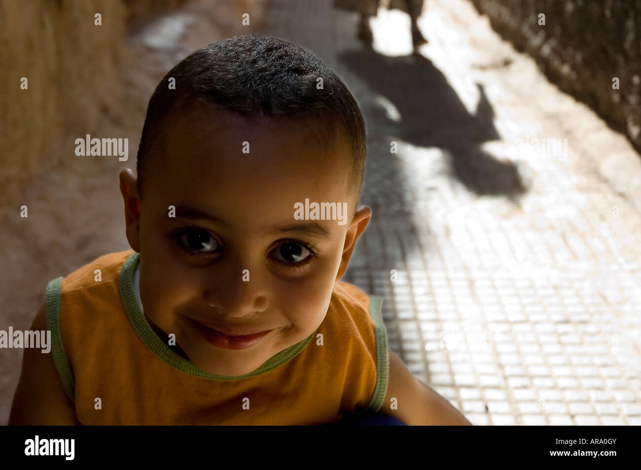 Portrait of a smiling cunning child during a play in the alleys of ...