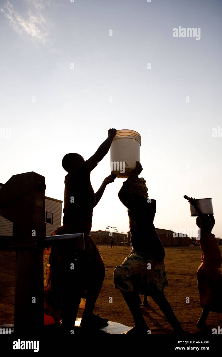 children collecting water at dusk in Malawi, Africa Stock Photo - Alamy