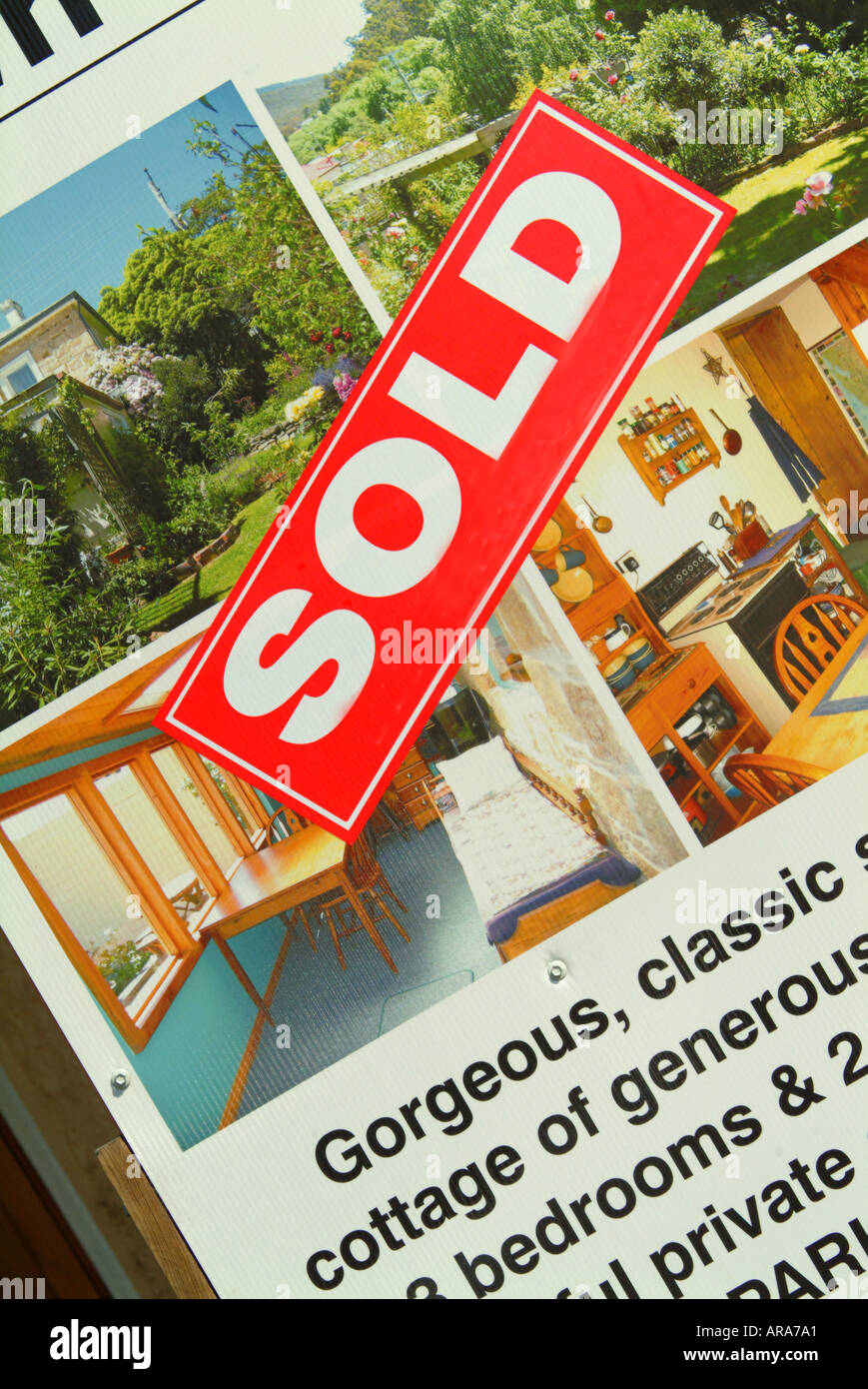 Real estate agent s sold sign Stock Photo - Alamy