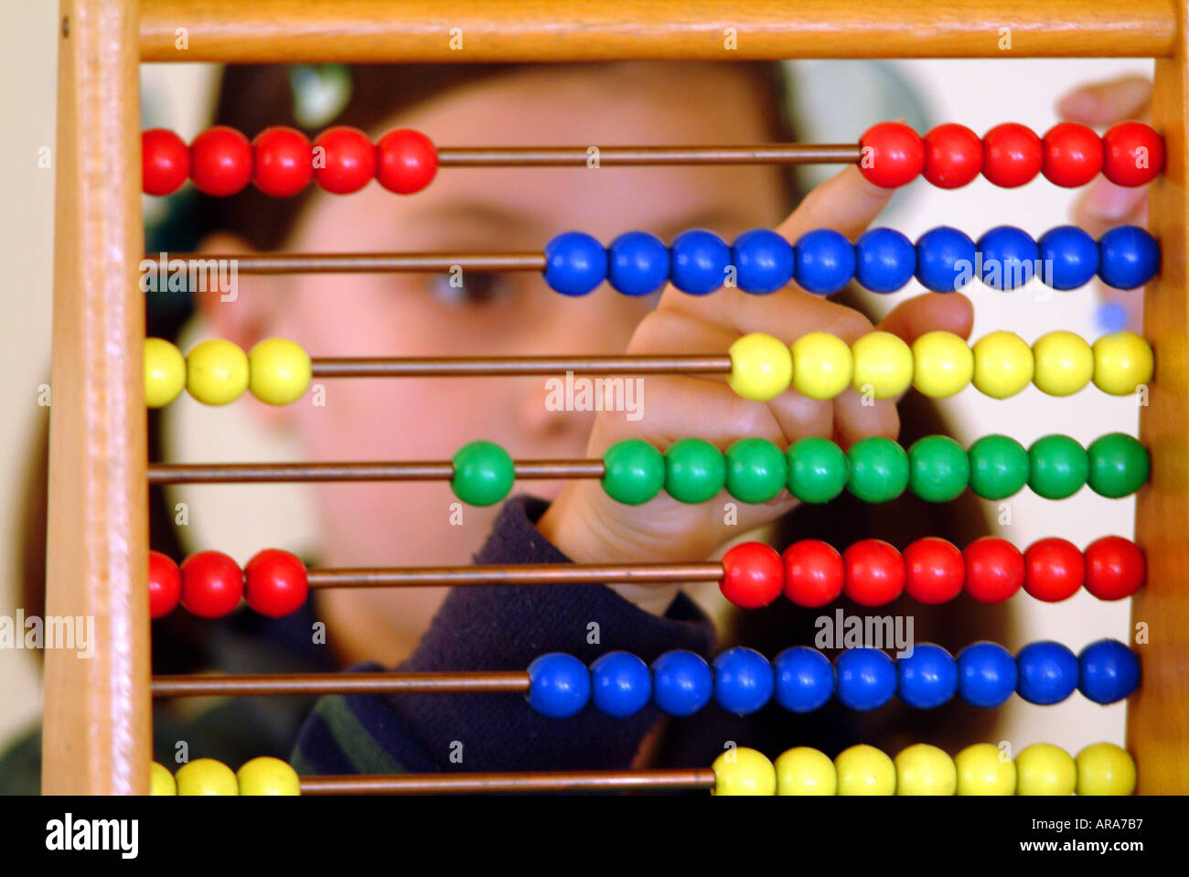 Child learning maths using a counting frame Stock Photo - Alamy