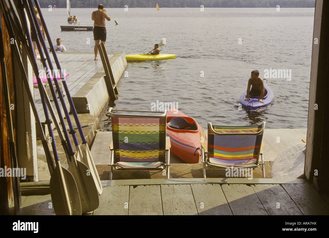 Young boys in colorful kayaks enjoy lake fun Stock Photo - Alamy
