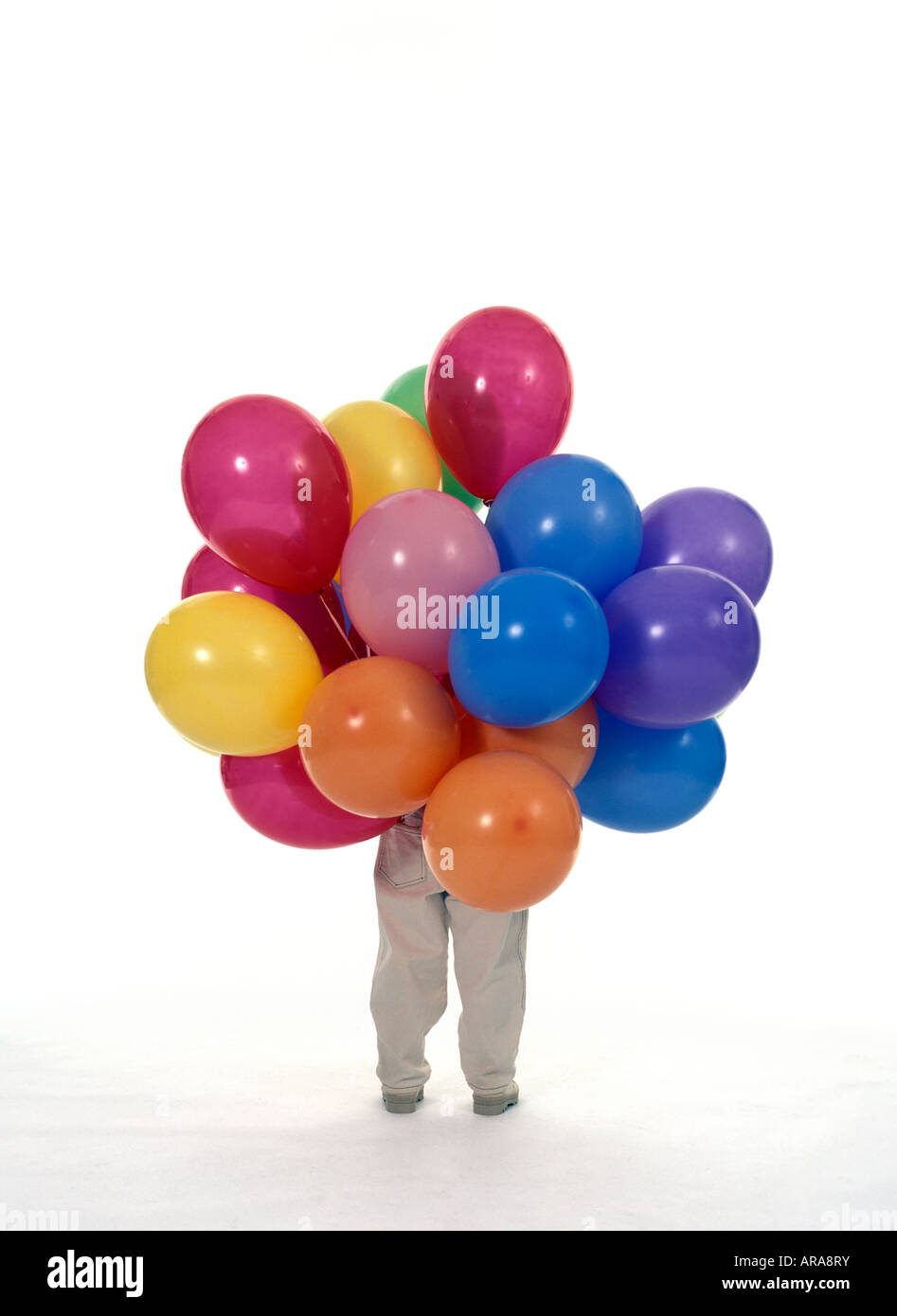 Boy hiding in coloured balloons Stock Photo - Alamy