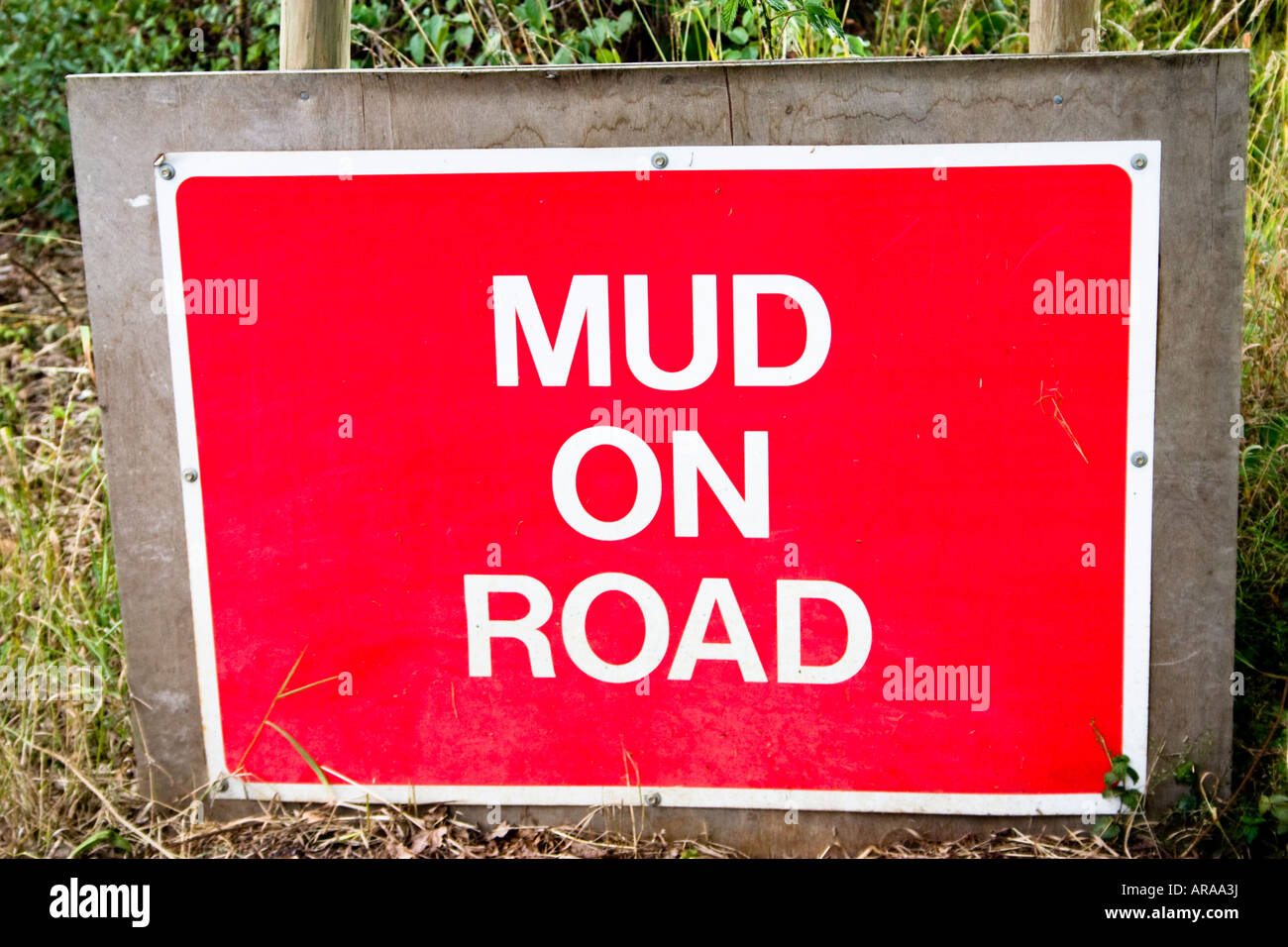 Mud on road road sign Stock Photo - Alamy