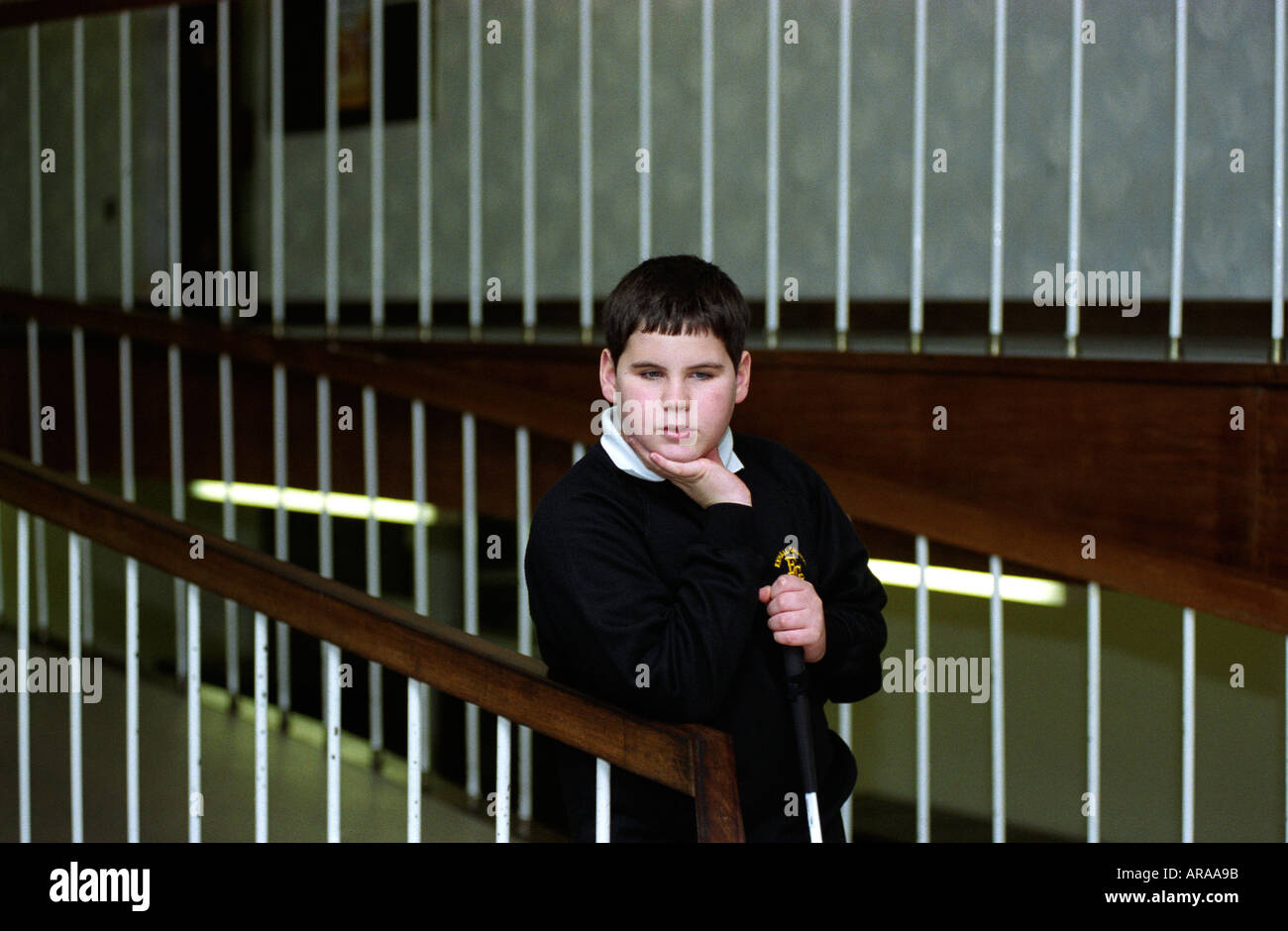 Portrait of a young visually impaired school boy at a special school UK ...
