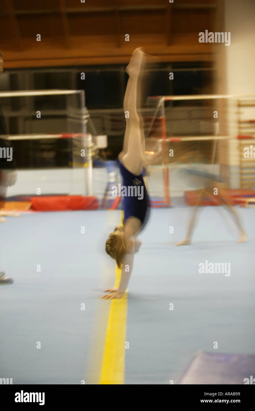 Girl doing handstand in gymnastics class Stock Photo - Alamy